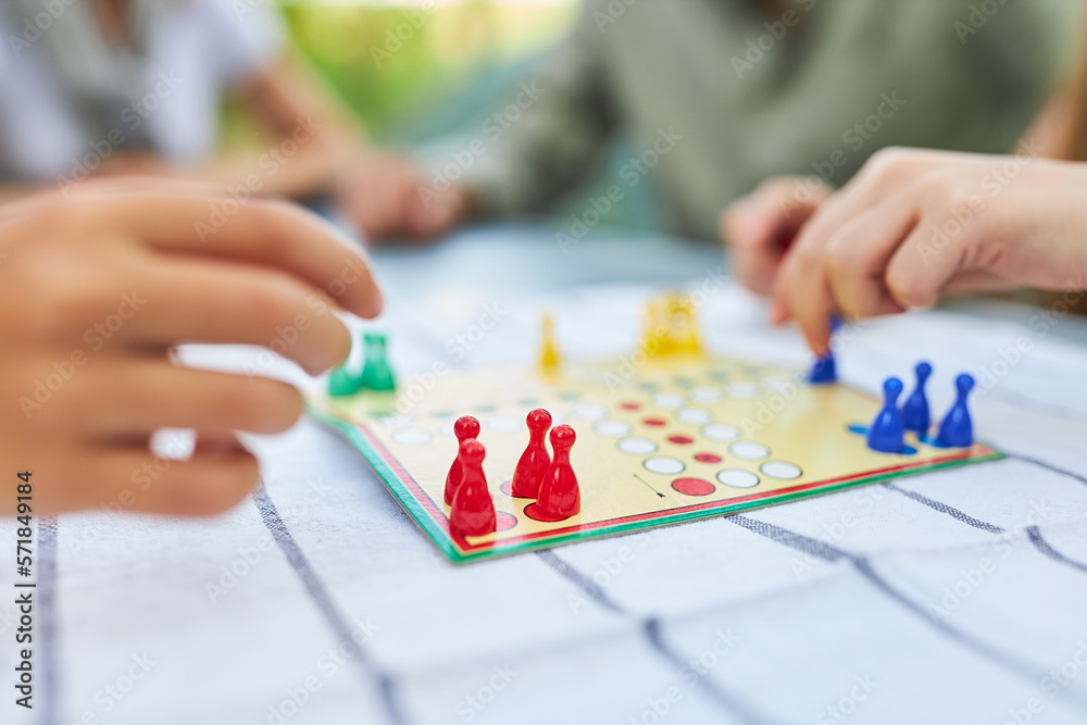 Children playing ludo with token on table in summer Stock Photo | Adobe ...
