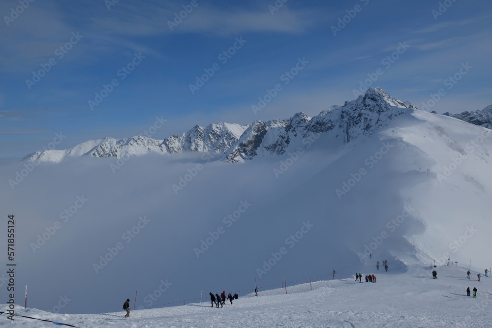 Little silhouettes of people on slope of Kasprowy Wierch Peak in Tatras ...