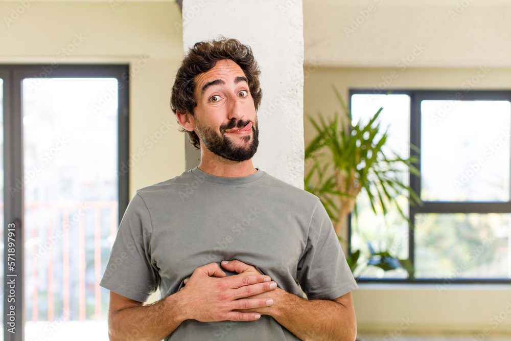 young adult crazy man with expressive pose at a modern house interior ...