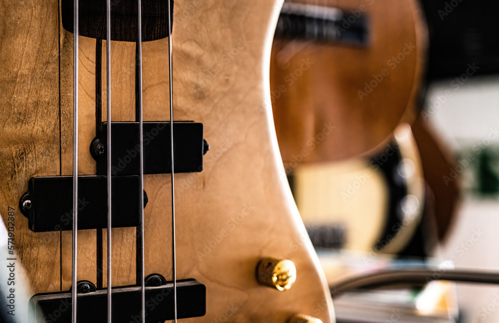 Bass guitar fretboardsand strings in music recording studio closeup ...