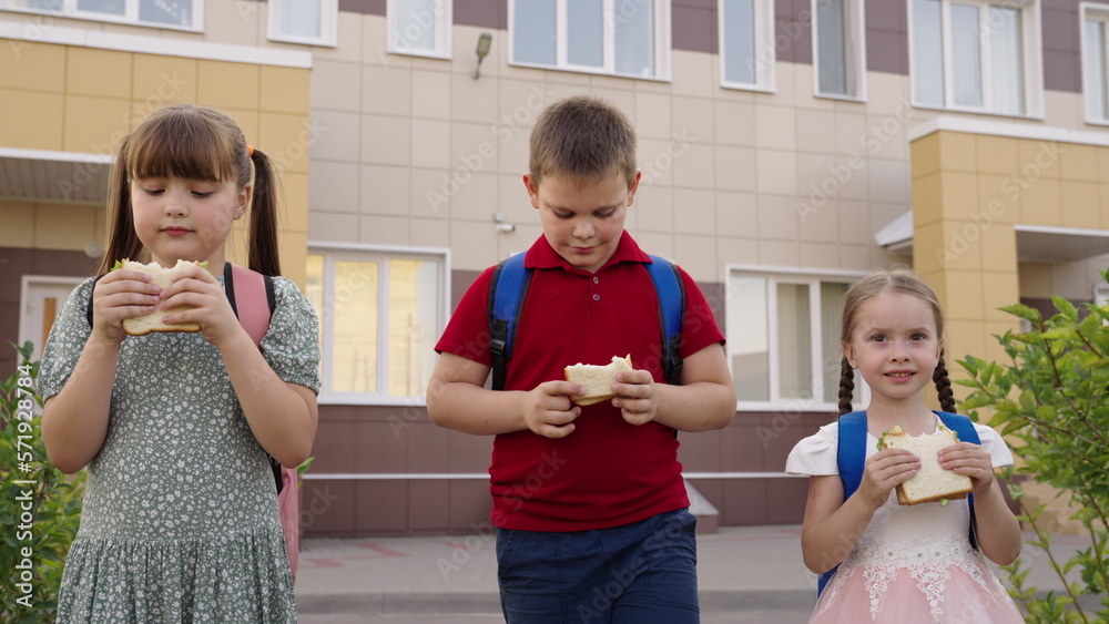 small children eat sandwiches. full child concept. boy girl have ...