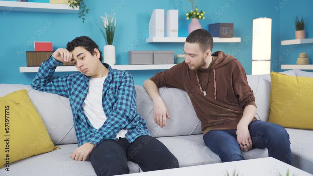 Young older brother listening to his sad brother and giving him morale ...