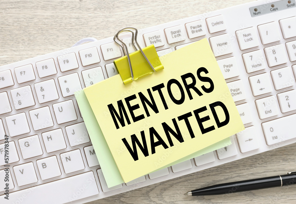 Mentor Wanted yellow sticker with a clip on a white keyboard. text in ...