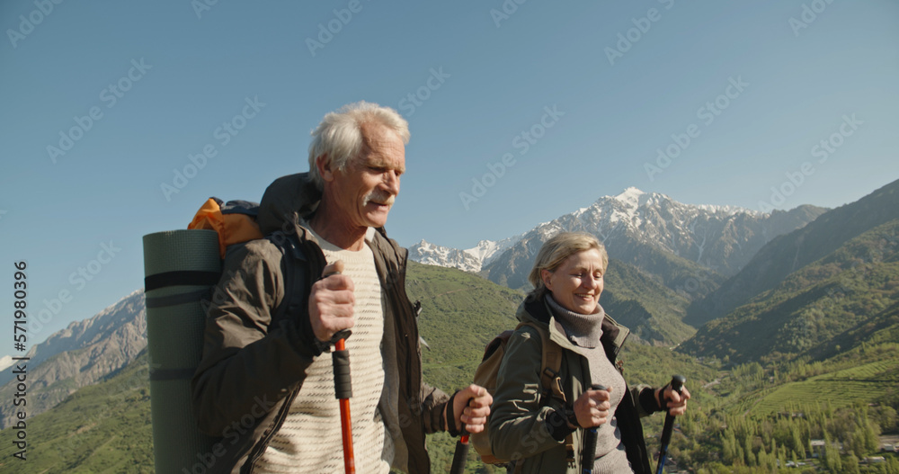Portrait of lovely happy elderly couple on morning walking outside in ...