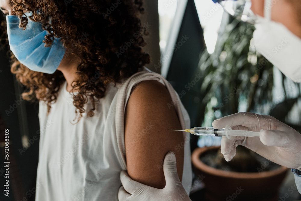 COVID-19 vaccine shot, hispanic doctor holds syringe and makes ...