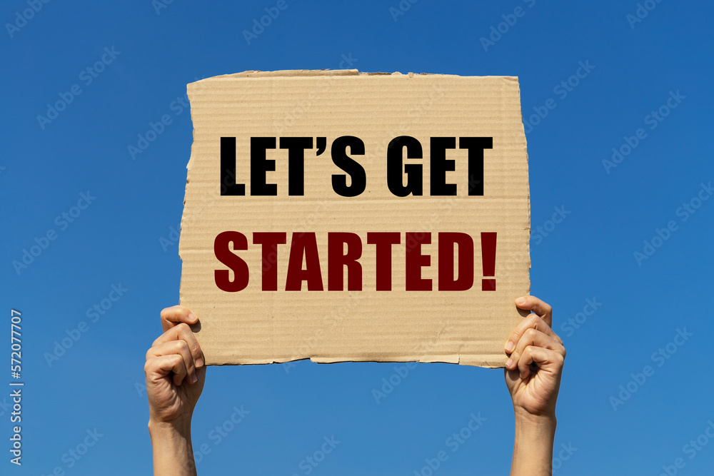 Let's get started text on box paper held by 2 hands with isolated blue ...
