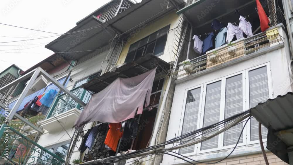 Traditional Vietnamese housing and balconies with flags and clothes ...