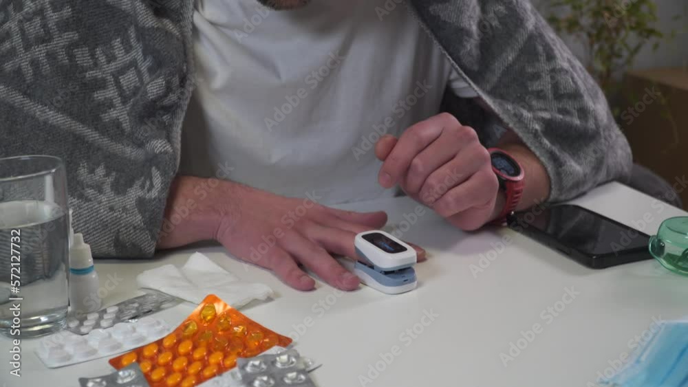 Young man use medical device, putting on fingertip to measure ...