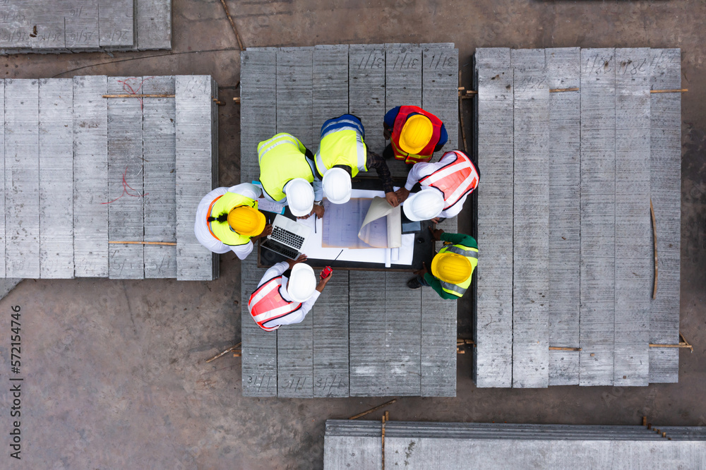 Aerial top view of architect and engineer discussing building plan at ...