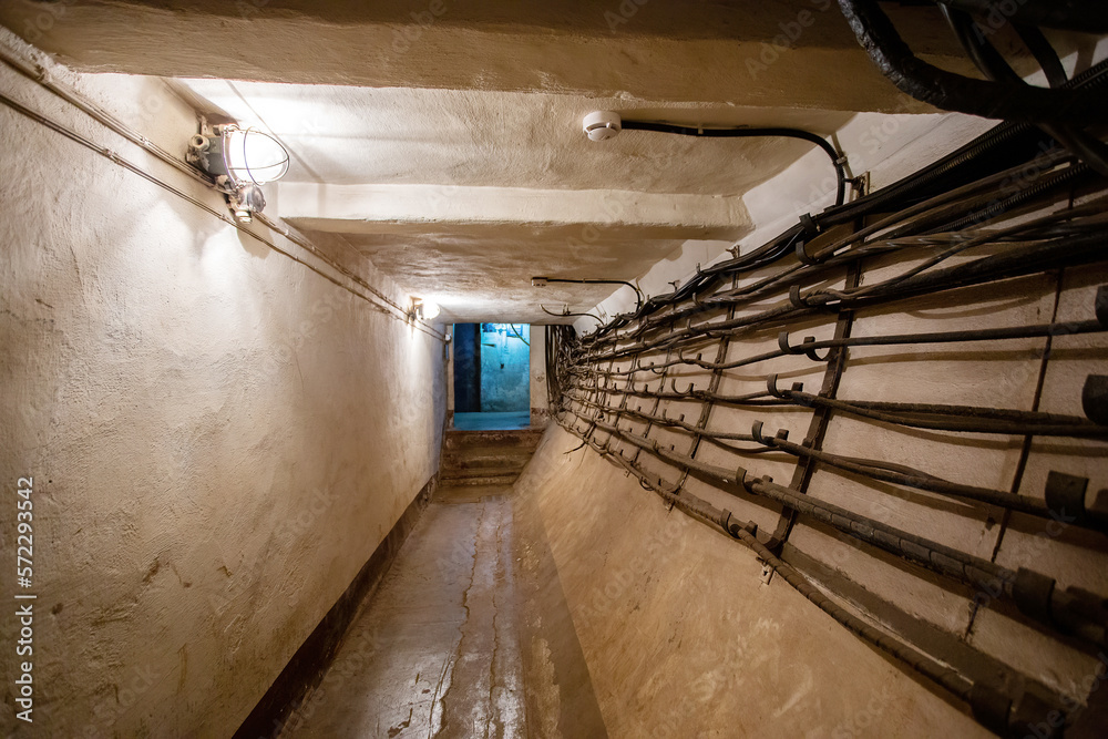 Abstract dark corridor of military bunker interior, grungy old ...