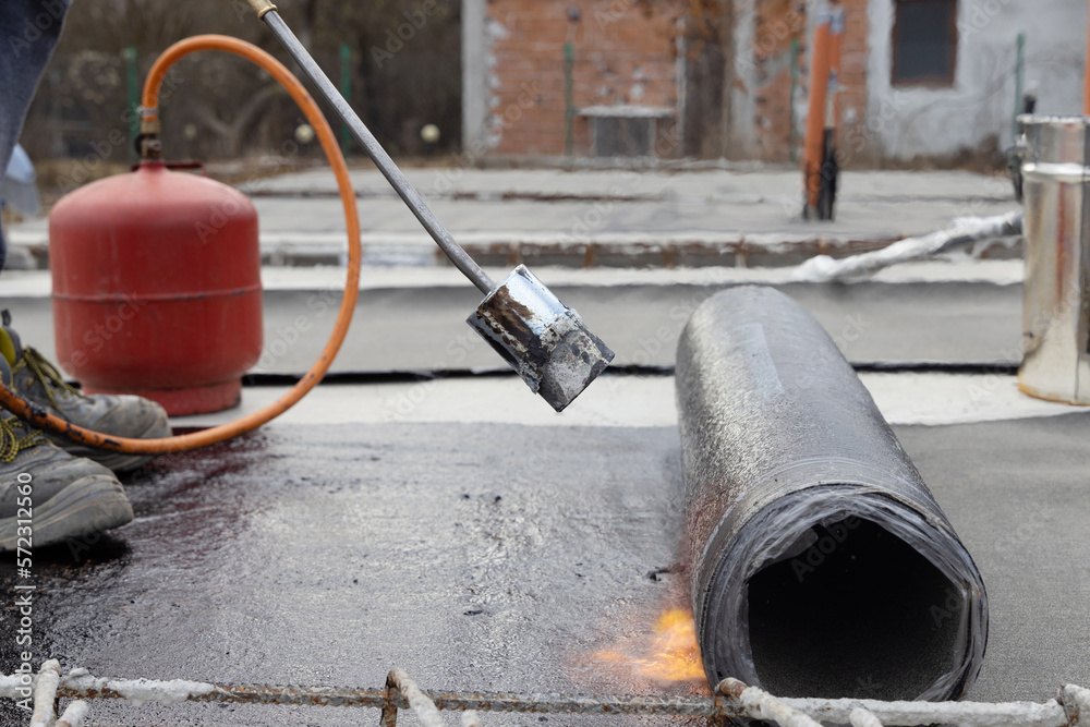 Laying Bitumen Insulation with Gas Blowtorch on a Concrete Slab Stock ...
