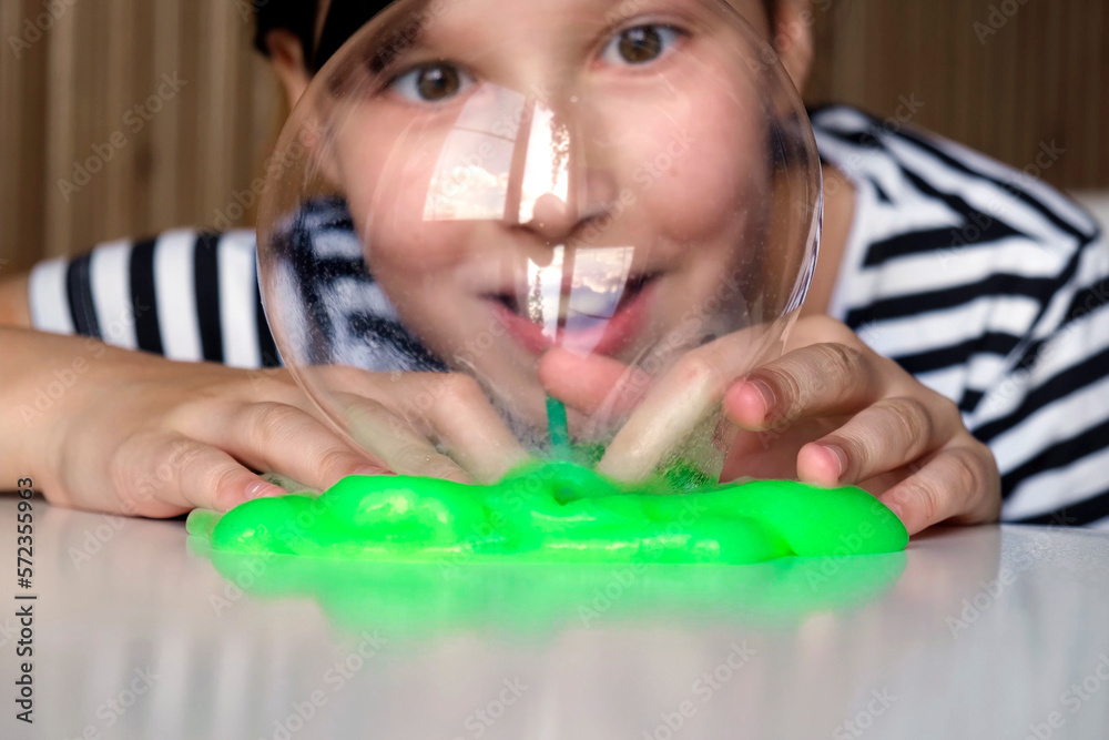 Playing with textured slime with bubbles, stretching the gooey ...