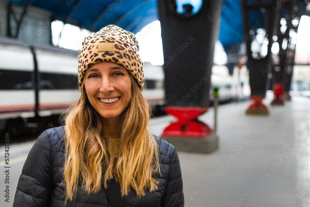 Girl having fun at the train station with an animal print winter hat ...