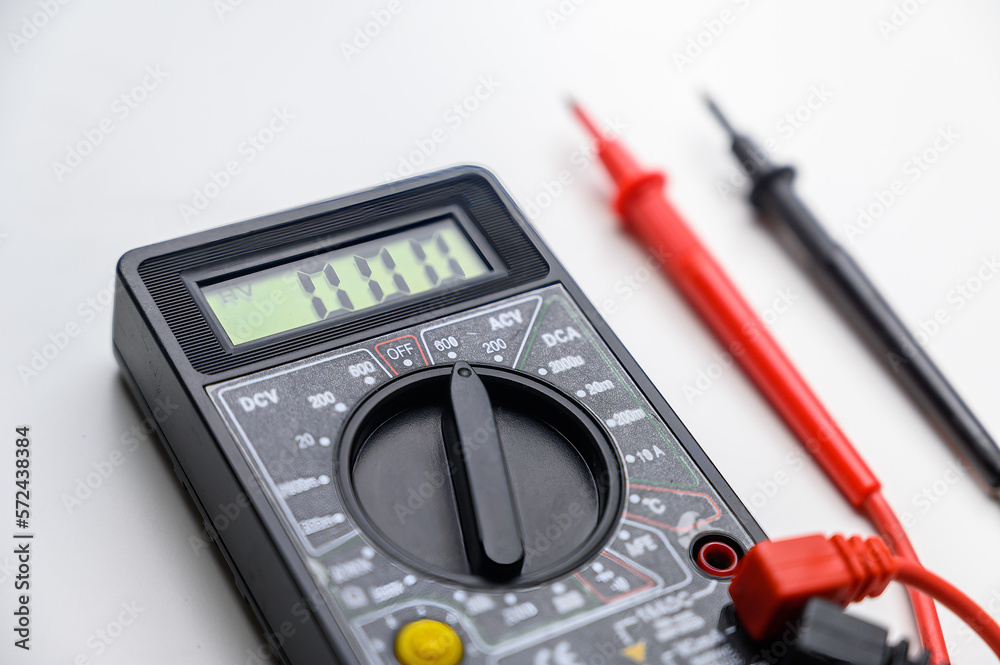 Digital multimeter on a white background. Tool for testing electrical ...