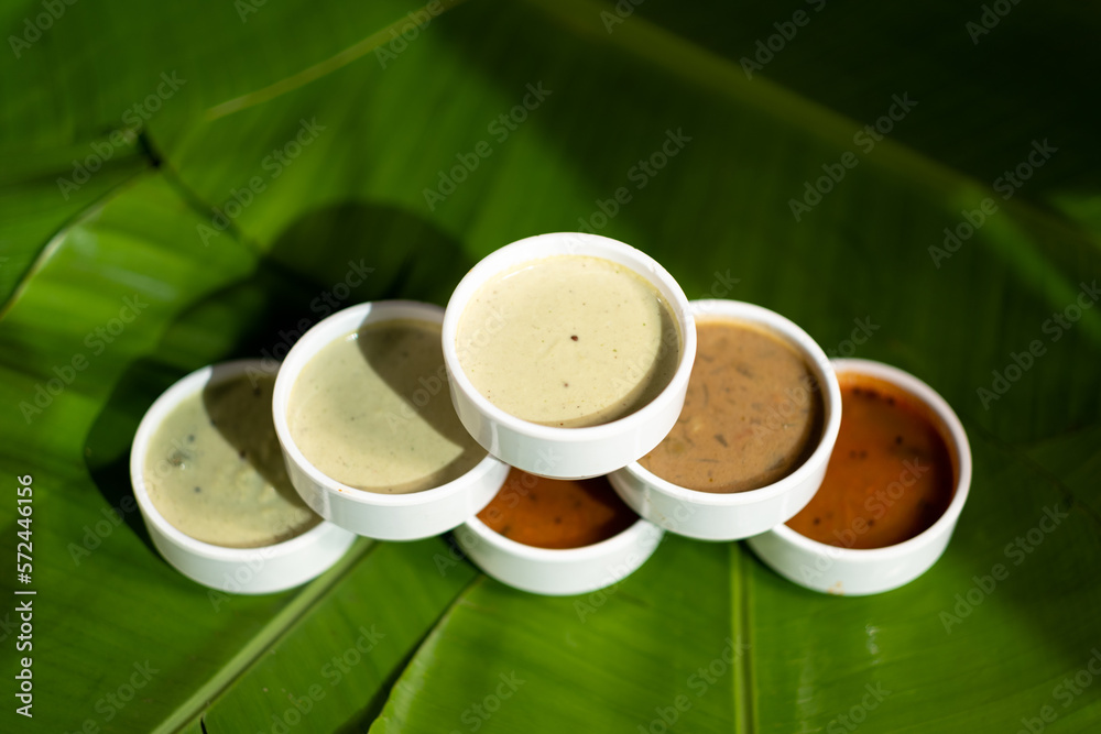 Various sauces that are a staple of Indian cuisine, against a backdrop ...