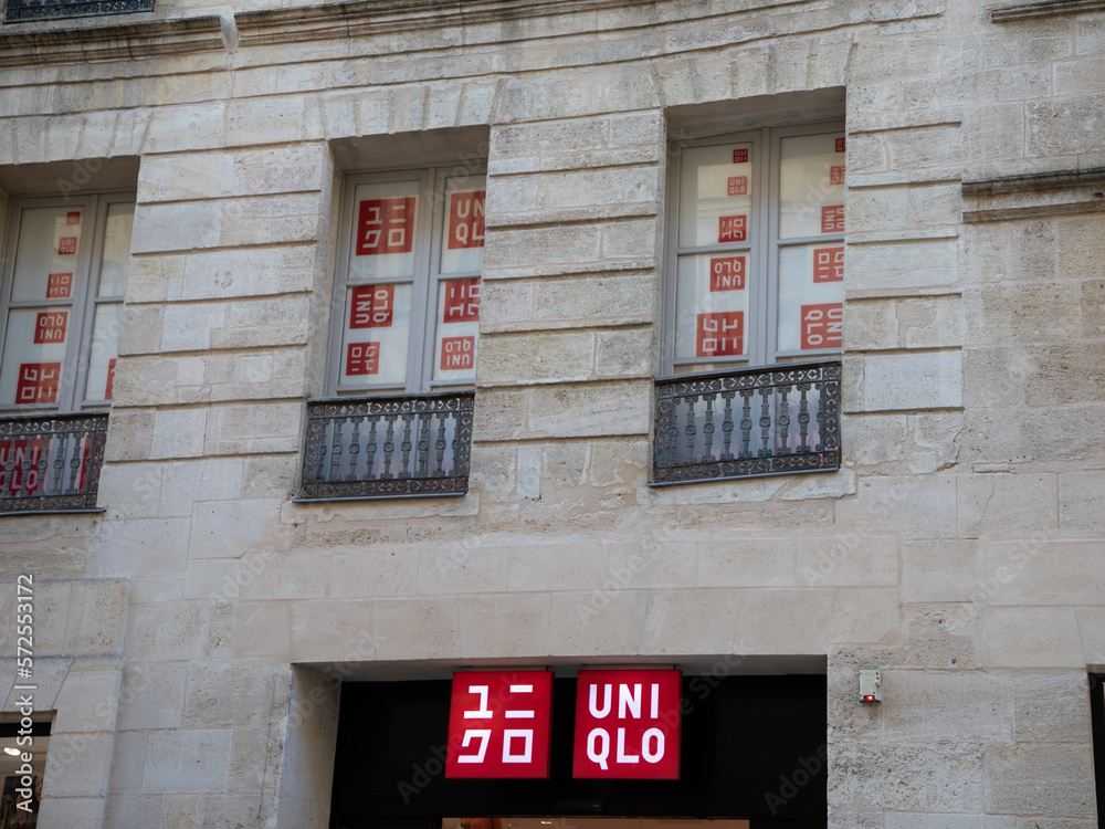 Uniqlo logo brand and text red sign store clothes facade wall shop from ...