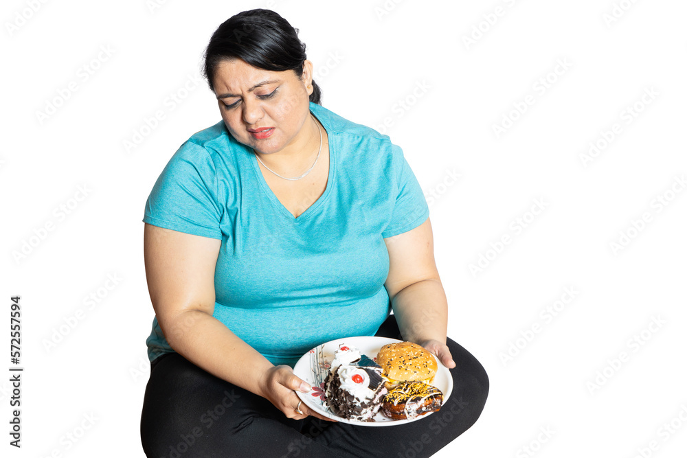 Overweight indian woman sitting with plate full of unhealthy food like ...