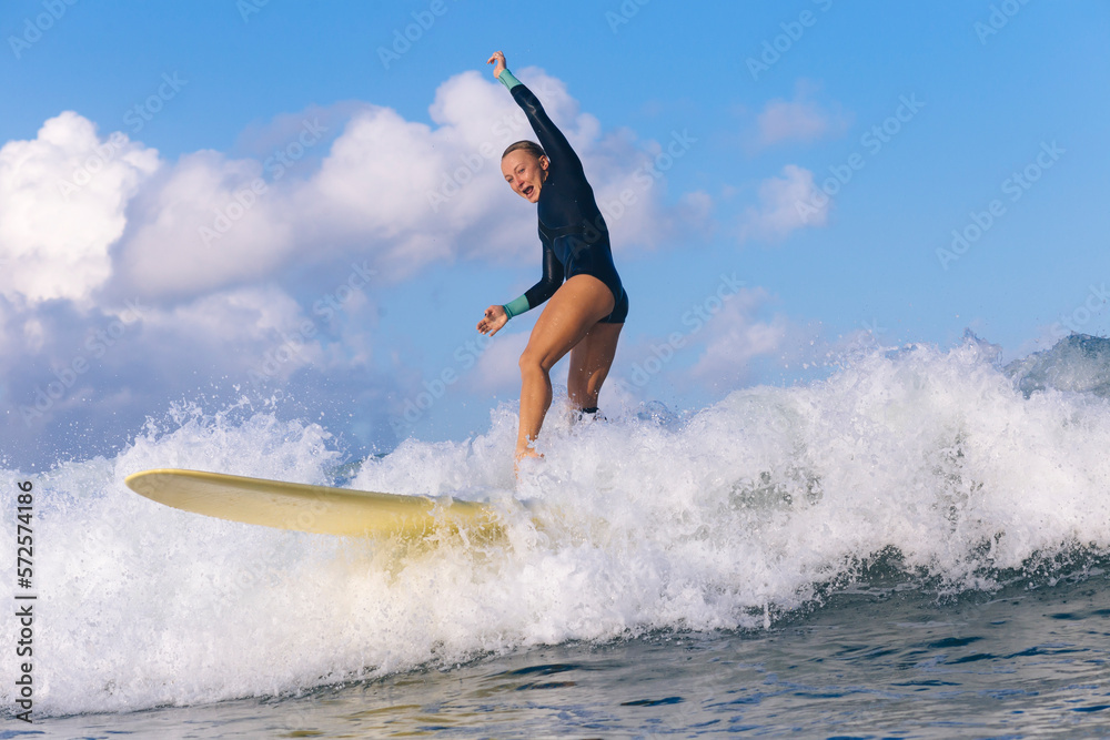 Female surfer riding wave against clouds, Male, Maldives Stock Photo ...