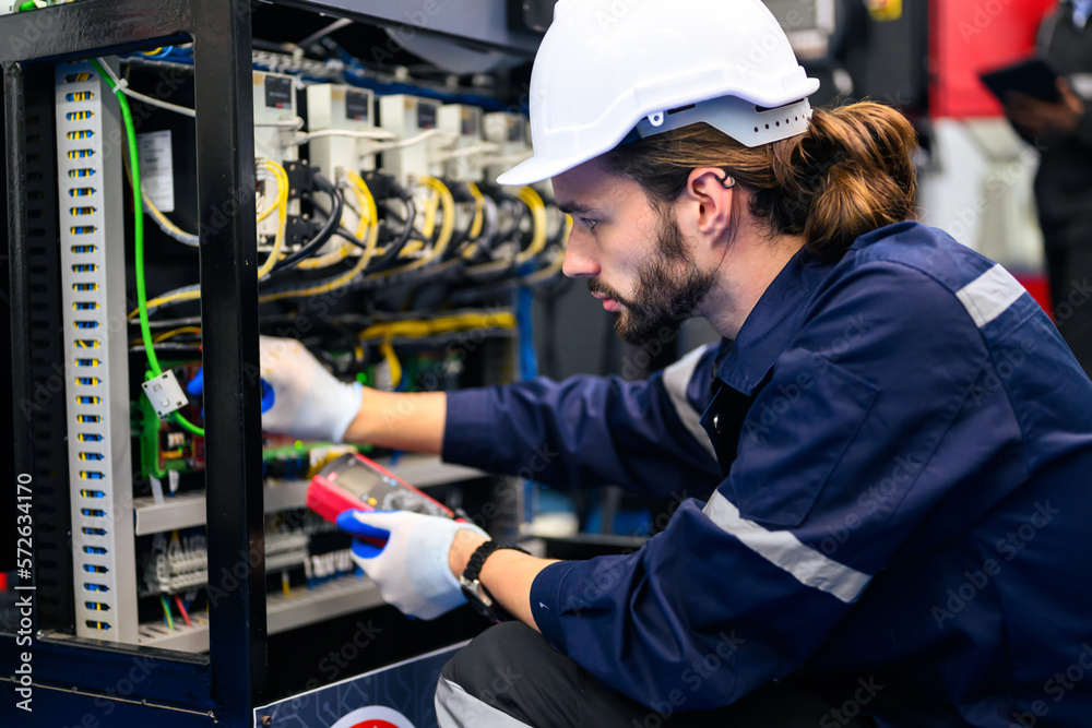 Technician engineer holding robot controller checking and repairing ...