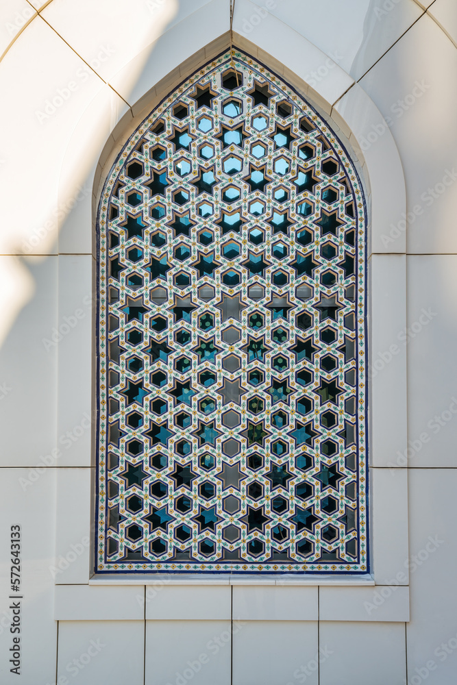 The window of a Muslim mosque behind bars in the form of a geometric ...