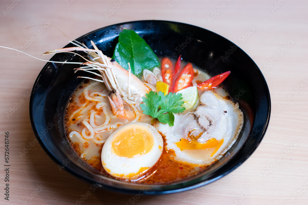 Stockfoto Tom Yum Ramen topped with chashu pork, soy sauce pickled eggs ...