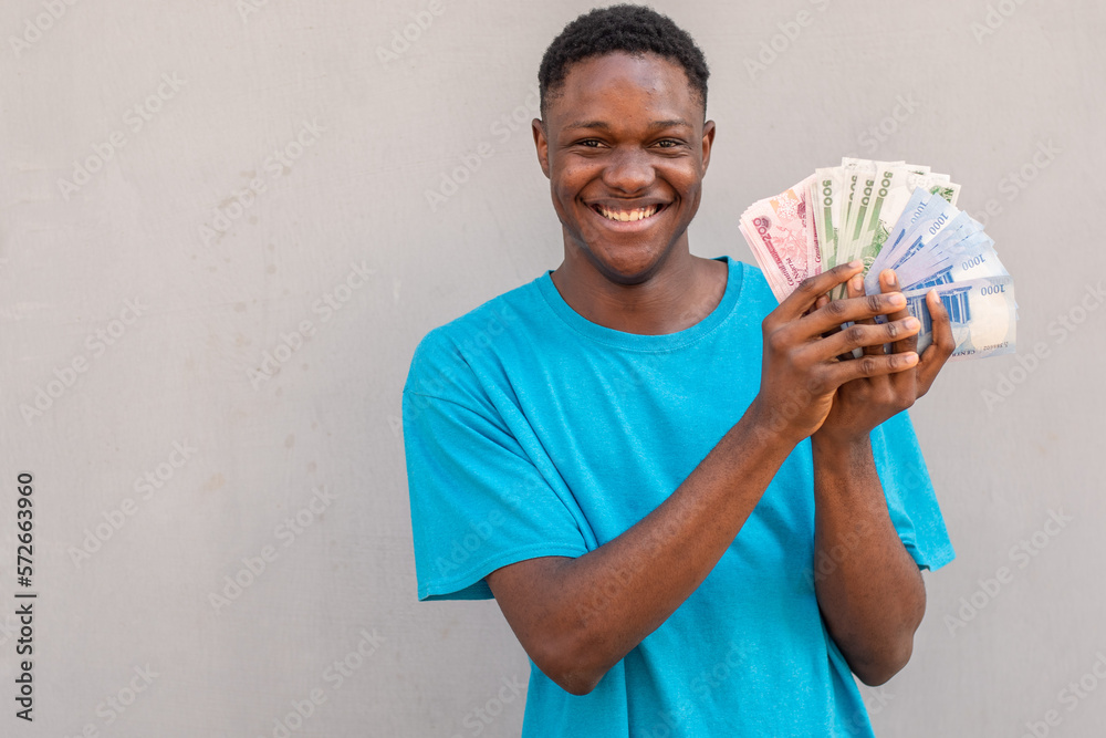 man holding the new nigerian naira notes Stock Photo | Adobe Stock