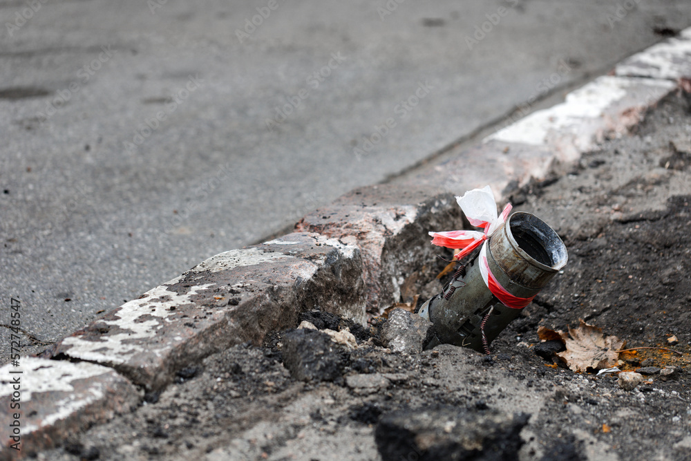 Fragment of a Russian rocket 122mm hail sticking out of the asphalt in ...