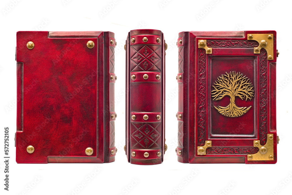 Aged red leather book with the tree of life in the center of the front ...