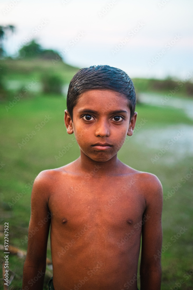 Foto de Portrait of a south asian teenage village boy , shirtless rural kid showing his muscular ...