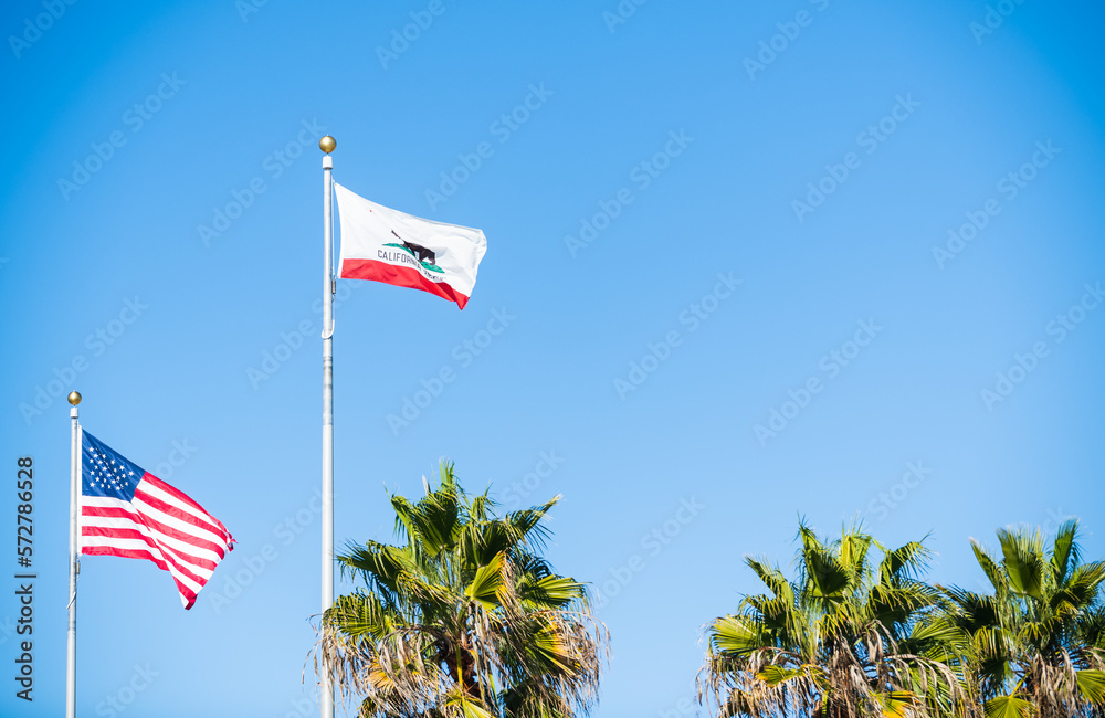 California flag and USA flag waving in the wind at the Santa Monica ...