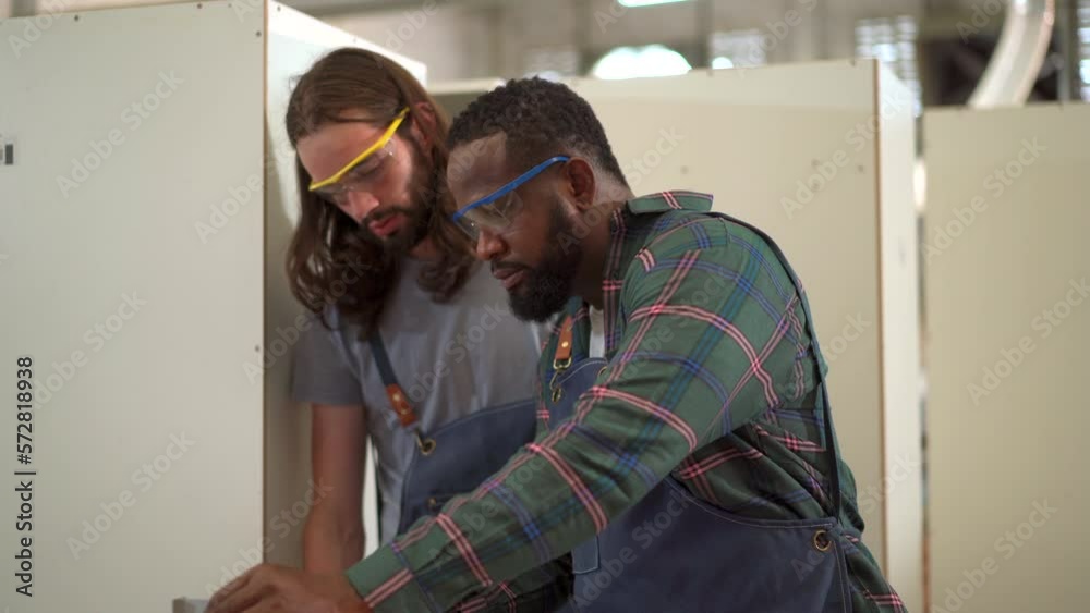 Professional carpenters using a ruler and spirit level to measures a ...