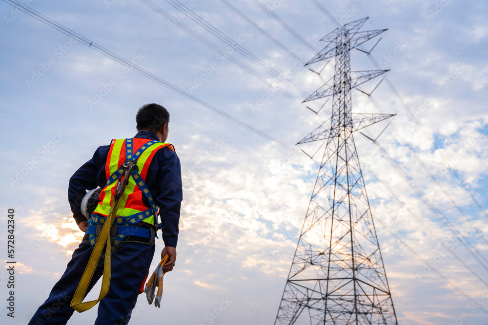 A Technician or Worker holding a safety helmet and gloves wear fall ...