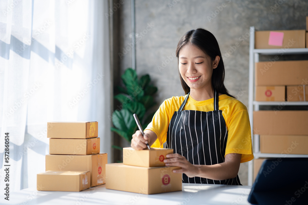 Online store salesperson is writing a customer's shipping address on ...