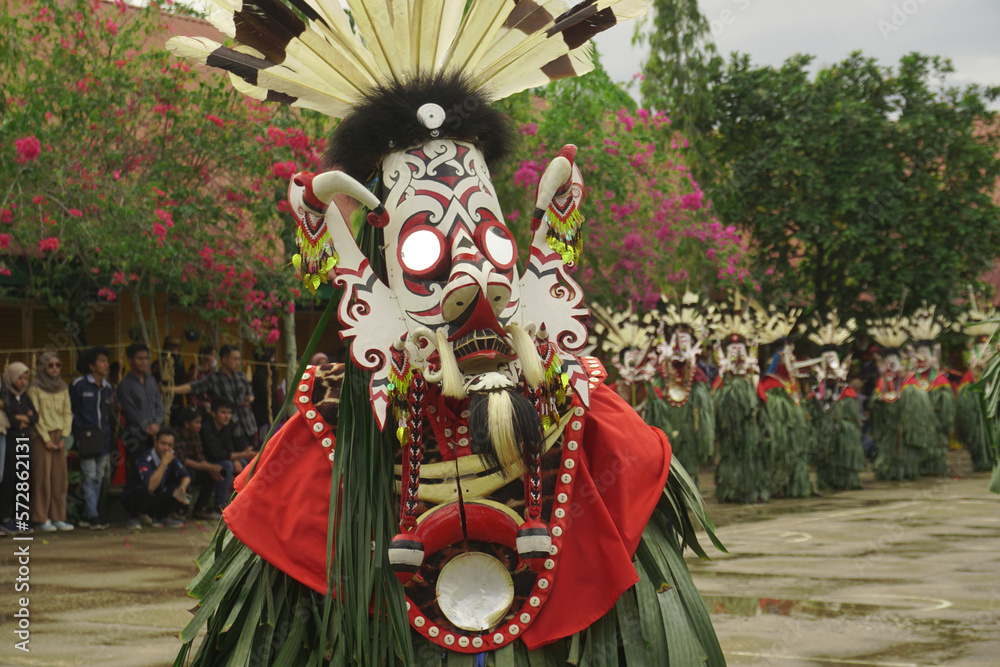 the scene of hudoq dancers marching in order to perform sacred rituals ...