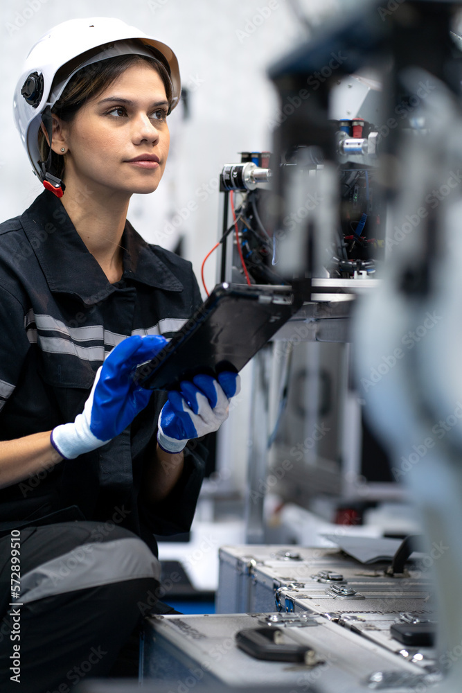 Computer science development engineer working on robotic arm connection ...