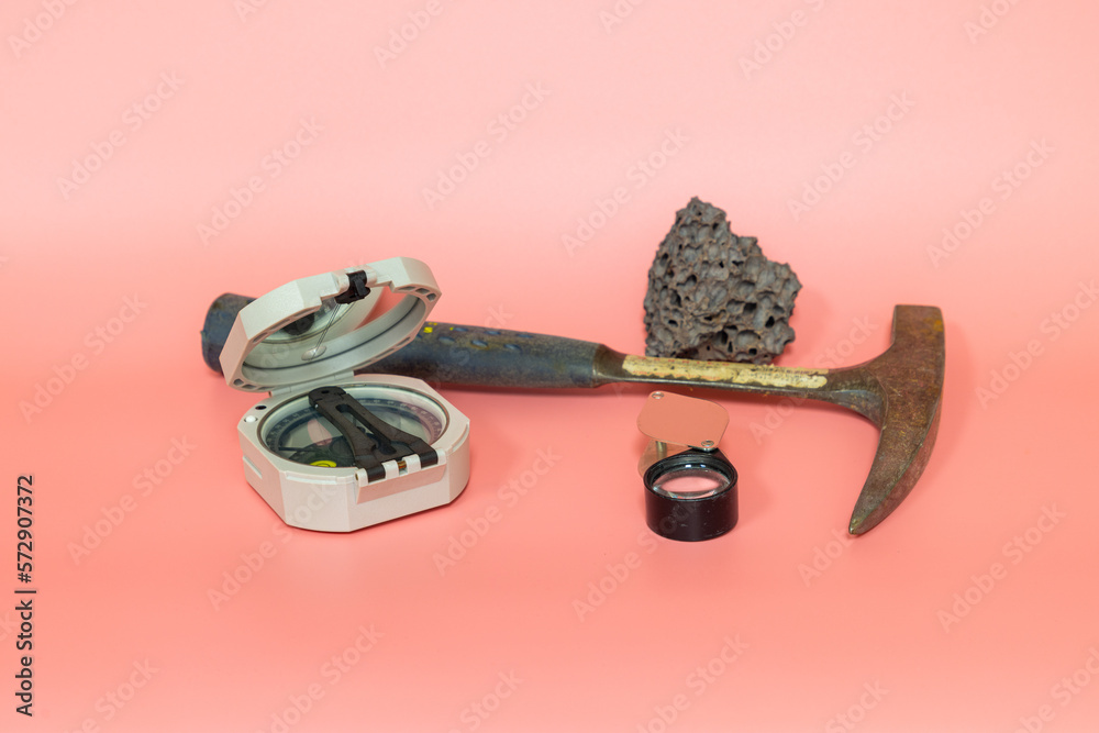 Geological fieldwork tools: hammer, compass, magnifying glass, rock ...