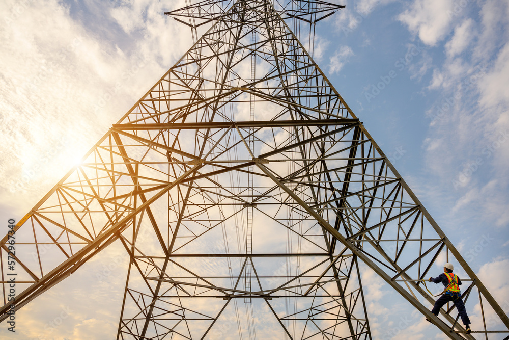 Electrician worker climbing electric pole at power station in order to ...