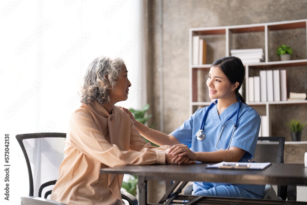 Young asian woman or nurse care hand on senior grandmother shoulder ...