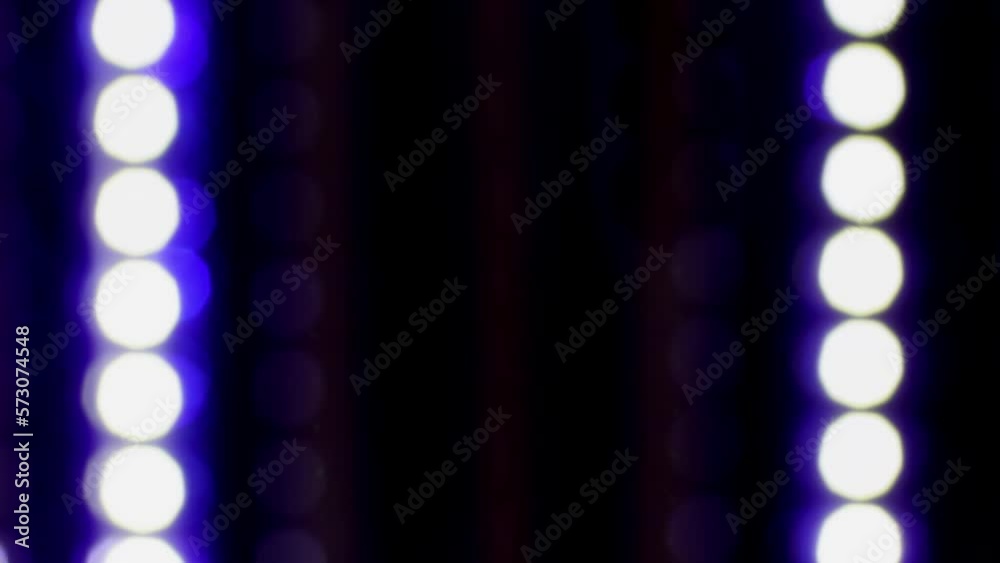 Vertically falling blur light circles. White bokeh with a blue outline ...