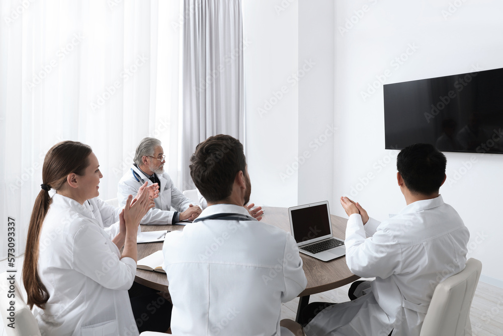 Team of doctors watching presentation on tv screen in room. Medical ...