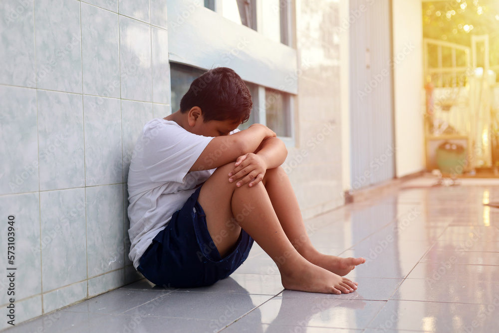 Depressed boy sitting on the terrace floor Stock Photo | Adobe Stock