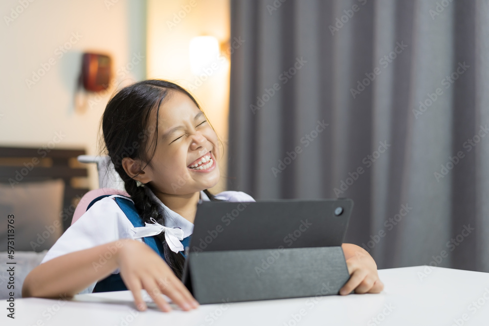 asian child smile learning on computer tablet or kid girl student ...