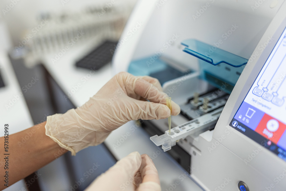 Female laboratory assistant making analysis with test tubes and ...