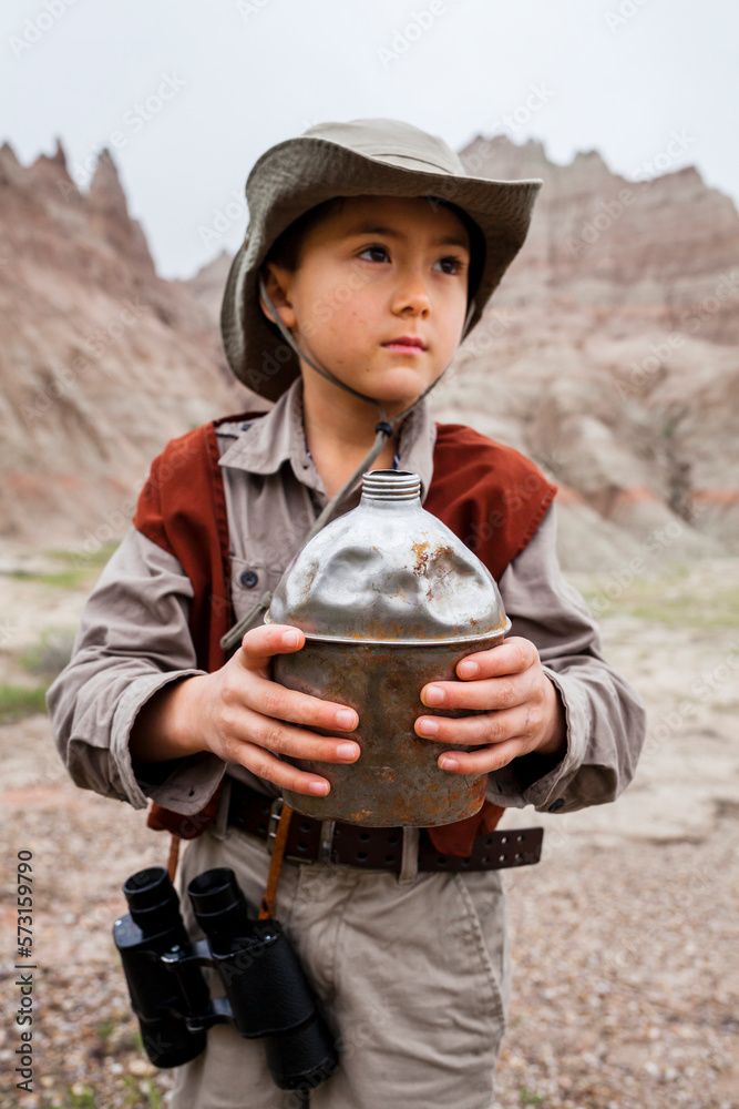 Boy wearing explorer costume holding water Stock Photo | Adobe Stock