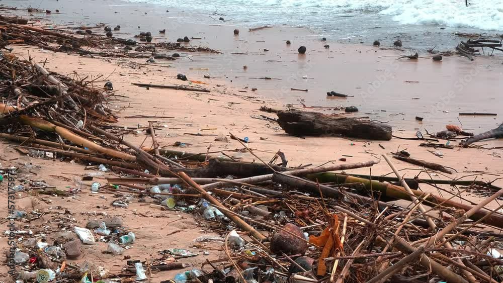 Tropical beach completely covered with garbage and waste. Ecological ...