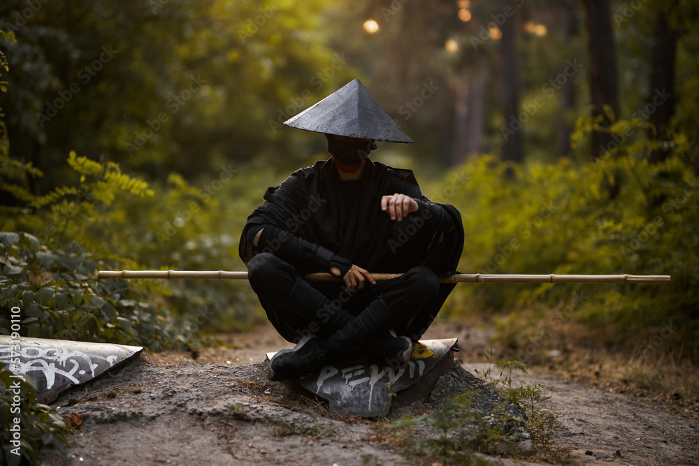 Surrealism theme: a man in a hannya mask, black kimono, black hat with ...