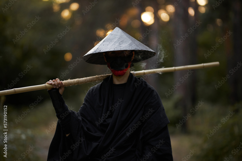 Surrealism theme: a man in a hannya mask, black kimono, black hat with ...