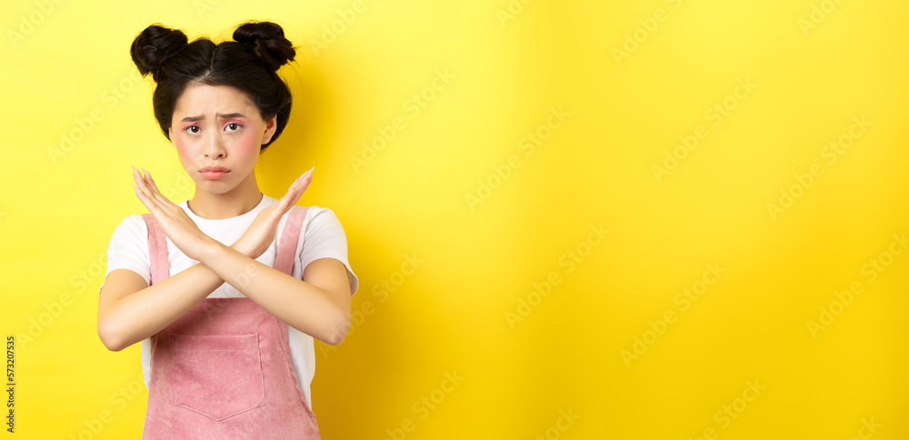 Sad girl begging to stop, frowning uspet and showing cross sign, say no ...