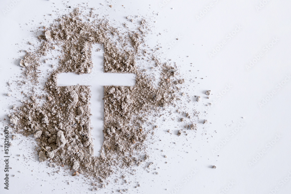 Christian cross or crucifix drawing in ash, dust or sand as symbol of ...