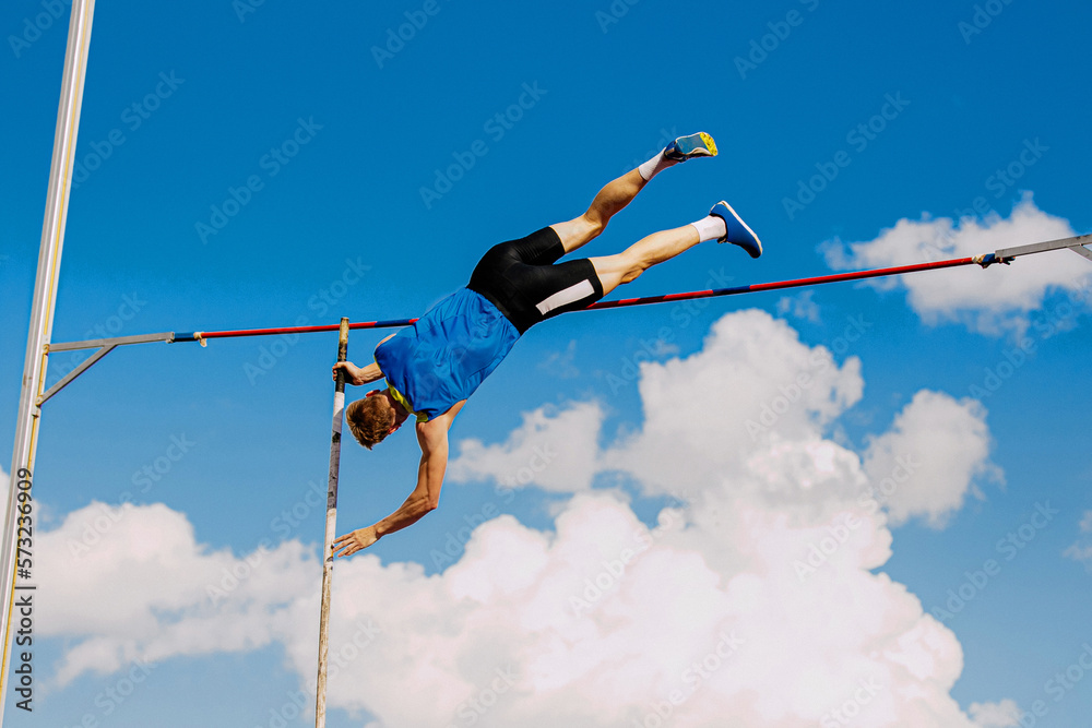 athlete pole vaulter in pole vaulting competition background blue sky ...